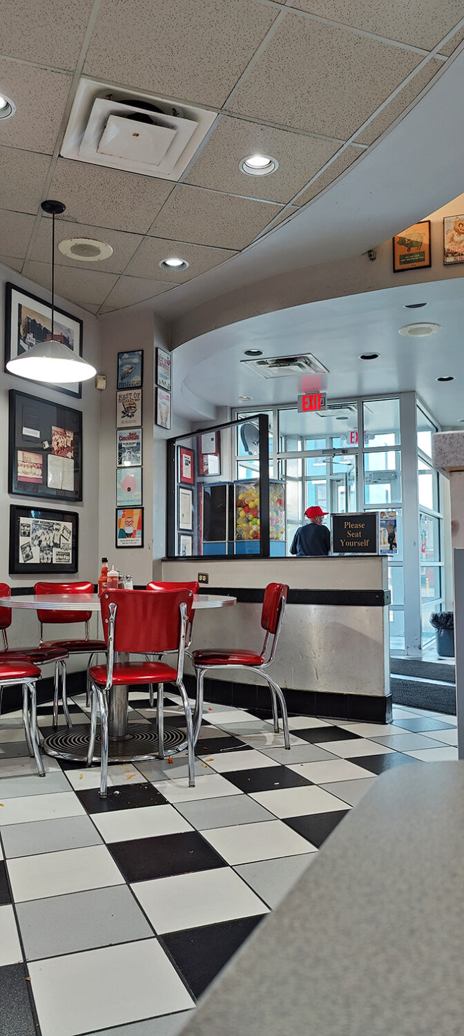 The classic diner interior with its "Please Seat Yourself" sign invites you to become part of a Cincinnati tradition that spans generations.