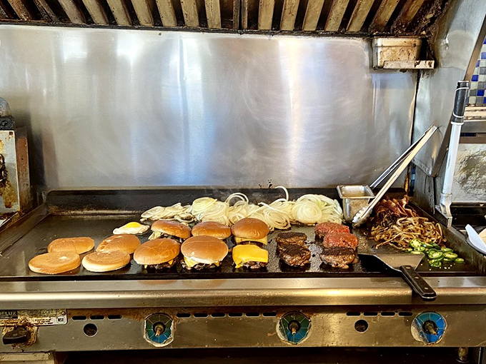 Burger ballet on the flat-top. This is where ordinary ingredients transform into extraordinary meals through heat, skill, and timing.