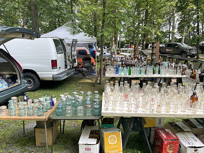 Glass menagerie in the woods. Sunlight transforms ordinary bottles into extraordinary jewels at this outdoor collector's paradise.