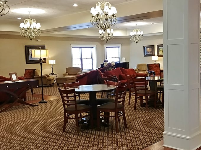 Elegant chandeliers illuminate comfortable seating areas where weary shoppers can rest before their next culinary adventure.