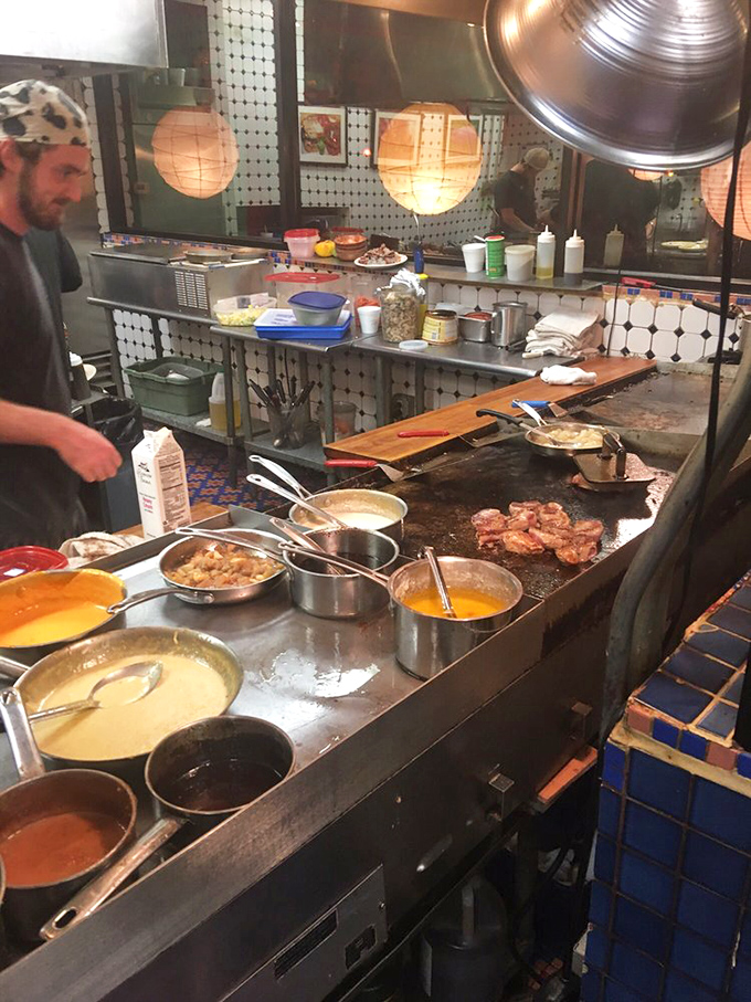 Where the magic happens &ndash; a bustling kitchen with sauces simmering and steaks sizzling, the culinary engine behind this colorful mountain gem.