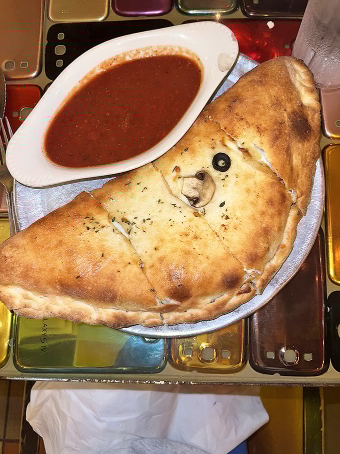 This calzone isn't just folded pizza &ndash; it's a self-contained treasure chest where X marks the spot with an olive and the gold is melted cheese.