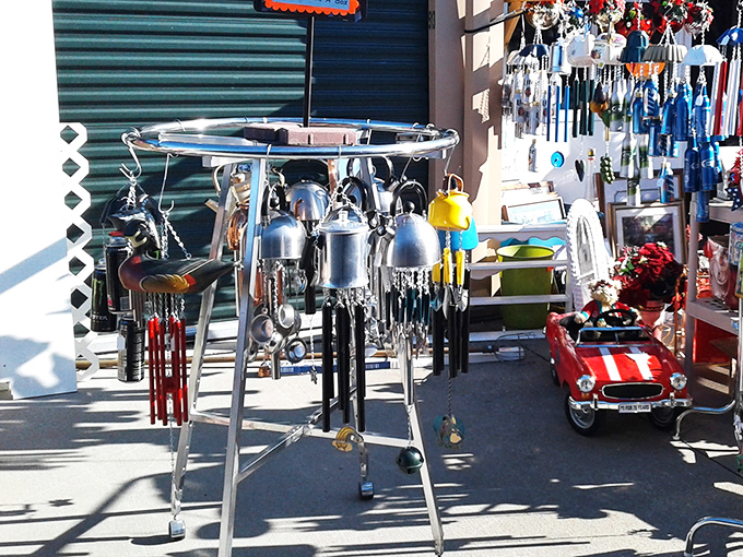 Wind chimes and miniature cars dance in the sunlight, creating that perfect symphony of kitsch that makes any patio feel like a Route 66 roadside attraction.