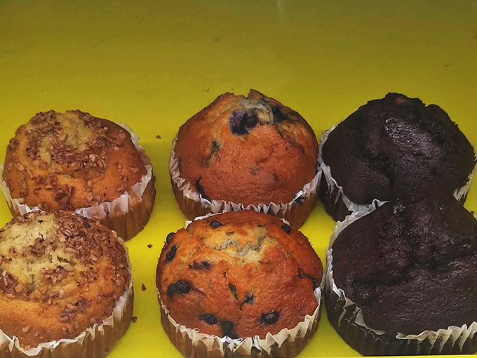 Muffins lined up like eager contestants in a delicious beauty pageant. From chocolate to blueberry, each one vying for the title of "Breakfast Champion."