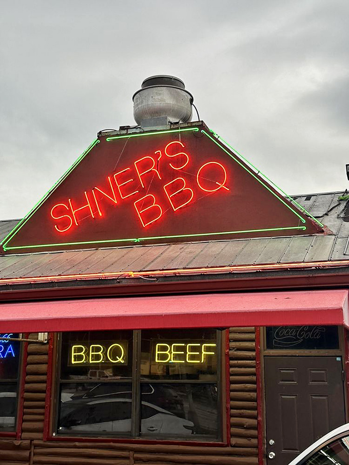 That neon sign glowing against the Florida sky &ndash; not just advertising barbecue, but promising a moment of pure, smoky bliss.