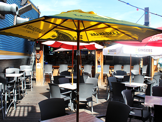 The outdoor deck at Cooper's&mdash;where summer dreams come true under yellow umbrellas and the lighthouse keeps watch over your seafood feast.