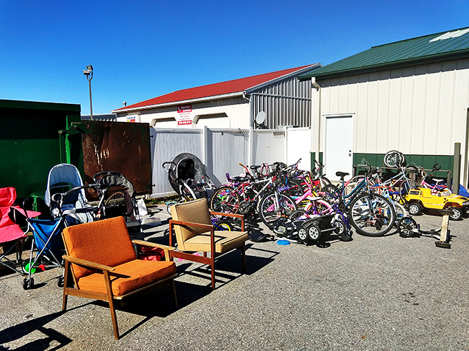 The outdoor overflow area—where patio furniture, bicycles, and outdoor gear wait patiently in the sunshine for their next chapter to begin.