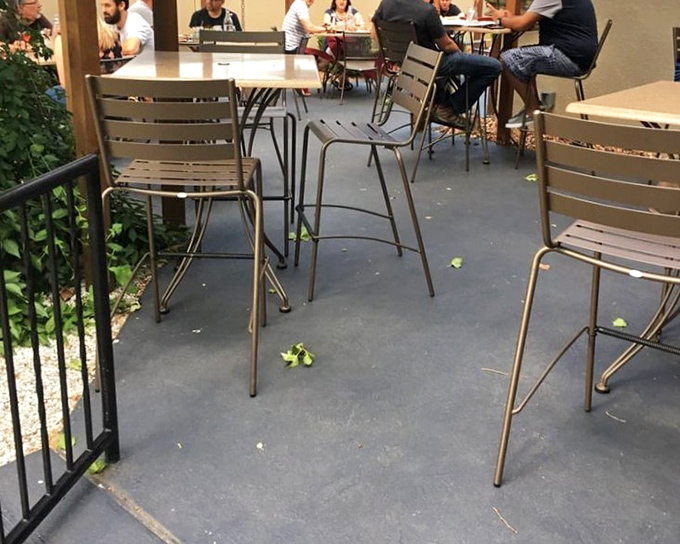 Outdoor seating for those who prefer their Southern comfort with a side of fresh air. Simple metal chairs invite you to linger over that last cocktail.