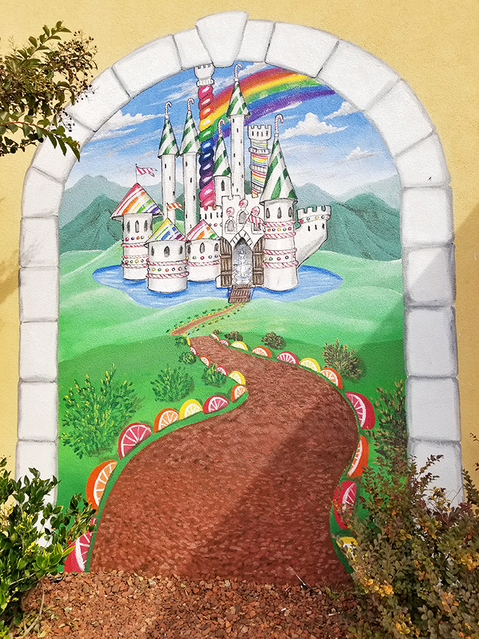 The painted candy castle mural promises a journey to a land where calories don't count and dentists are just mythical creatures.