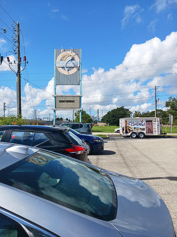 The sign that seafood lovers follow like a beacon. Cars in the parking lot tell the story—this place is worth finding, even if your GPS gets confused.