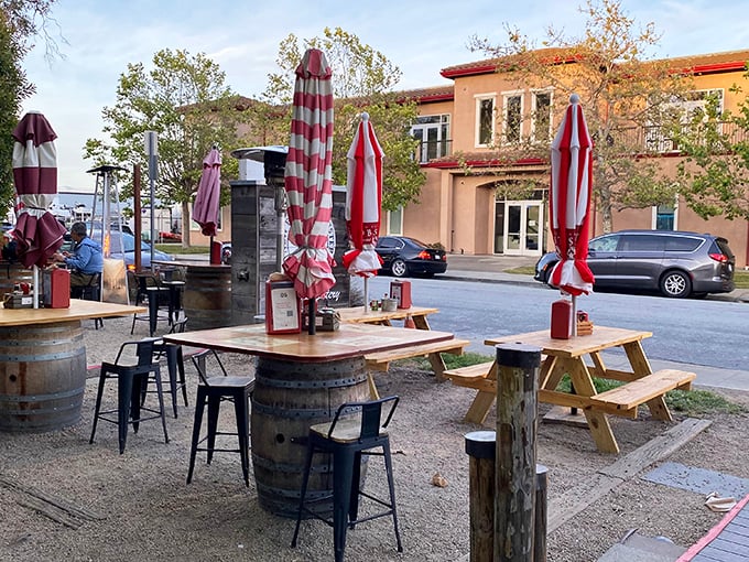 Wine barrels, picnic tables, and those signature red-and-white umbrellas create an outdoor oasis where time slows down and seafood takes center stage.