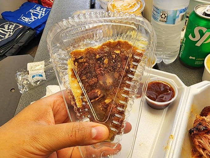 Pecan pie in its clear container &ndash; the sweet finale to a savory symphony. That glistening filling is nature's candy after a barbecue feast.