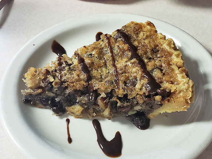 A slice of homemade pie that whispers, "Diets are overrated." The chocolate drizzle is just showing off at this point.