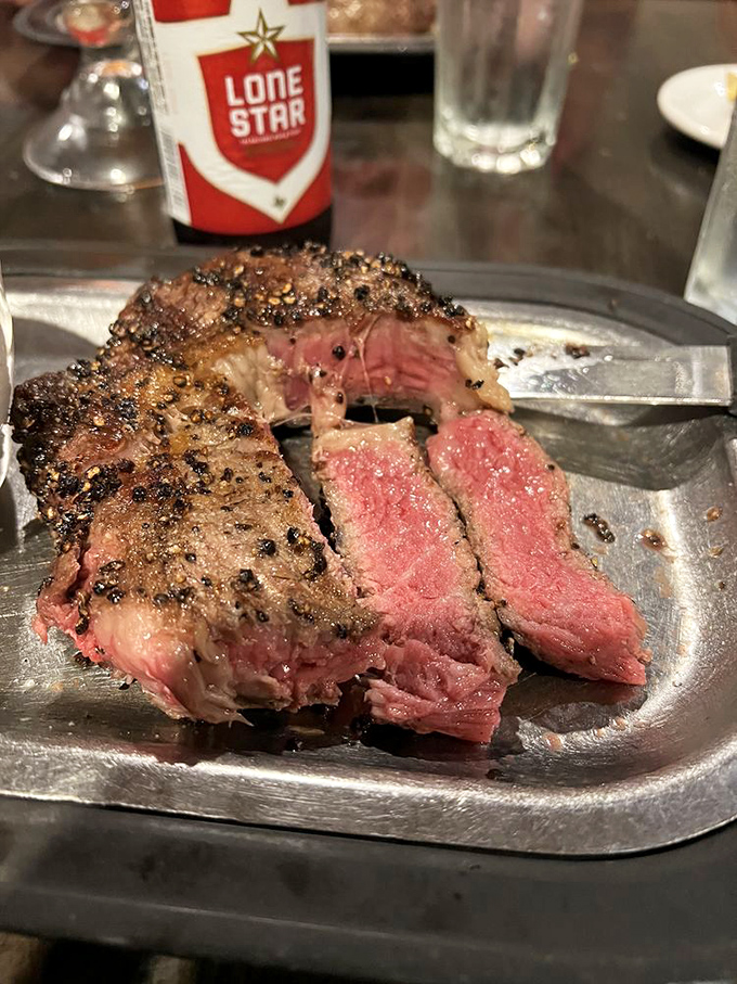 A perfectly cooked ribeye with a peppercorn crust that doesn't need fancy garnishes&mdash;just a cold Lone Star and your undivided attention.