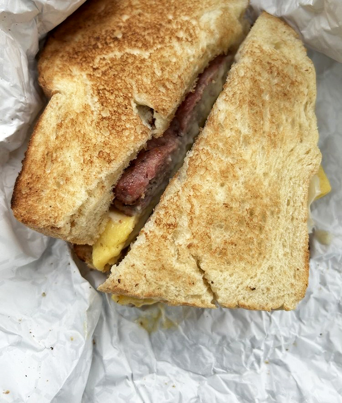 A breakfast sandwich that understands morning hunger isn't to be trifled with. Perfectly grilled bread embracing eggs and meat like old friends reuniting.