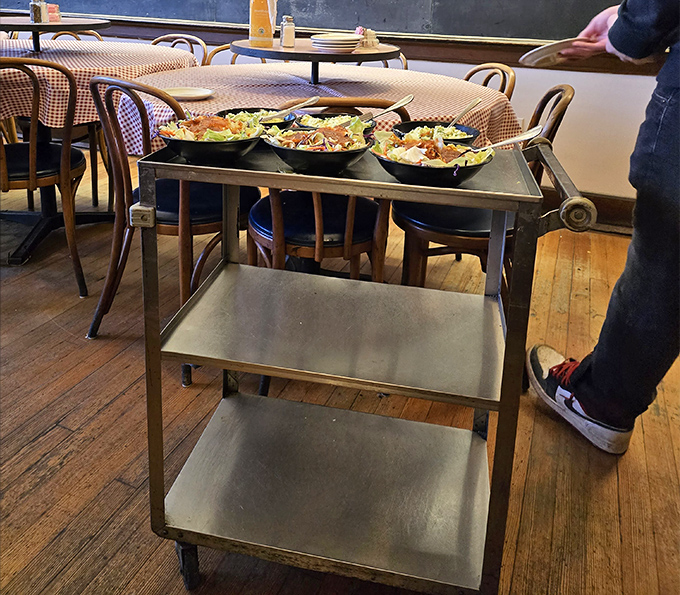 The serving cart loaded with fresh salads stands ready for deployment&mdash;the food equivalent of a well-organized lesson plan.