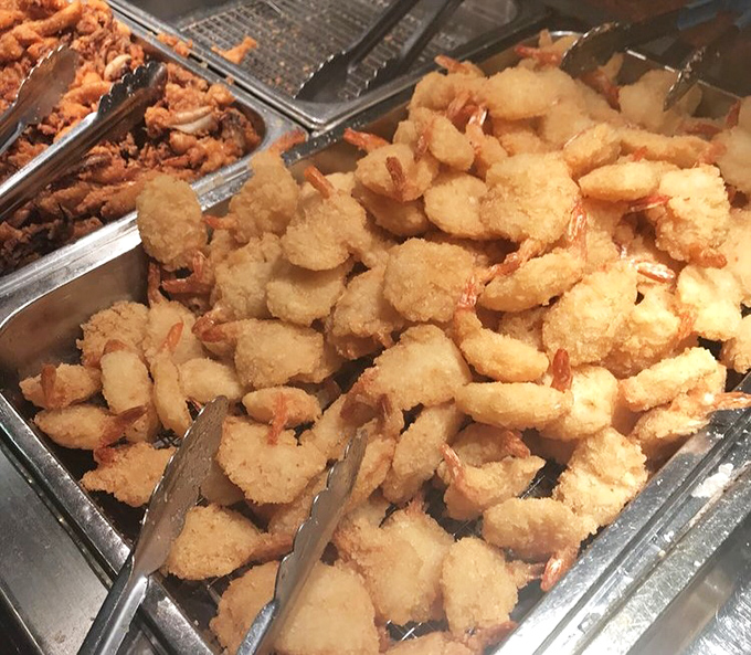 Golden-fried shrimp tempura glistening under heat lamps – crispy morsels that somehow maintain their crunch despite the buffet environment's challenges.