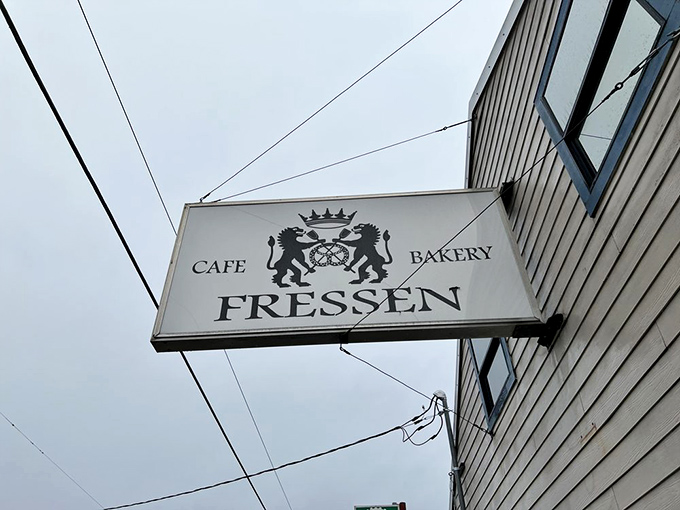 The Fressen sign proudly announces its dual identity as caf&eacute; and bakery&mdash;a coat of arms that promises carbohydrate royalty awaits inside.