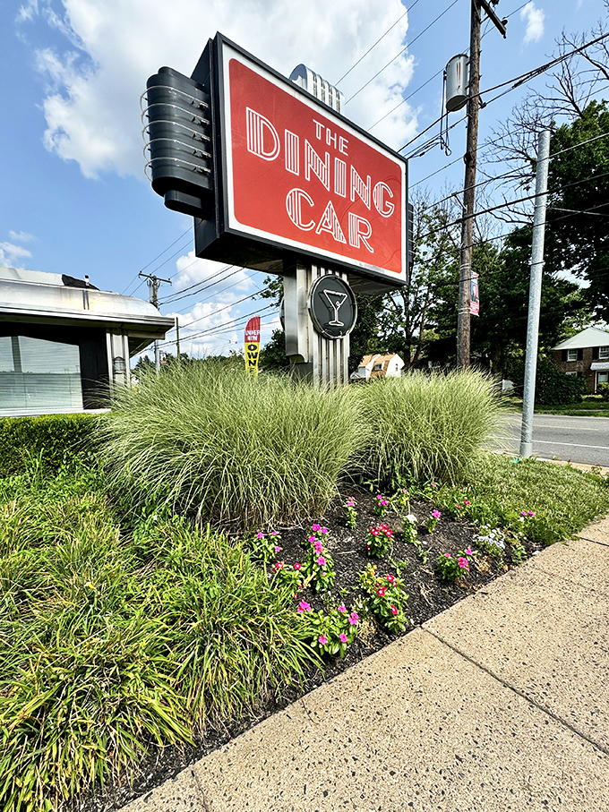 The iconic sign stands as a beacon of hope for the hungry, promising retro charm and timeless flavors just beyond its Art Deco lettering.
