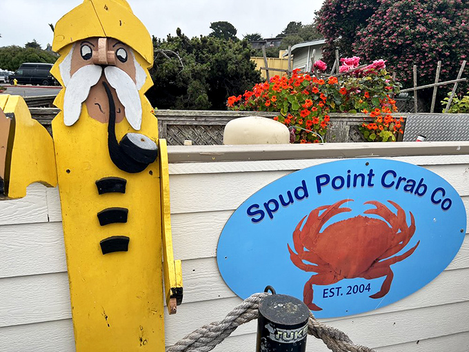 The whimsical sailor statue stands guard by the Spud Point sign &ndash; a quirky sentinel welcoming seafood pilgrims to chowder paradise.
