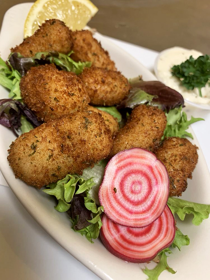 Crispy haddock croquettes nestled among colorful beets &ndash; British comfort food that's both photogenic and utterly craveable.