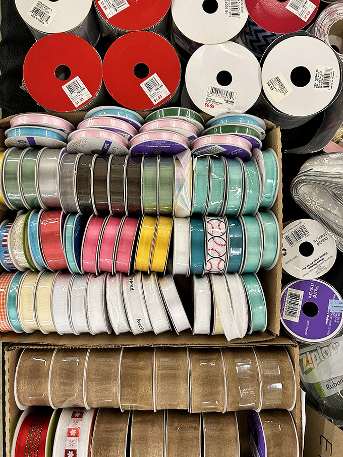 A crafter's color wheel of possibility! These ribbon spools are like fabric candy – impossible to choose just one and guaranteed to spark joy.