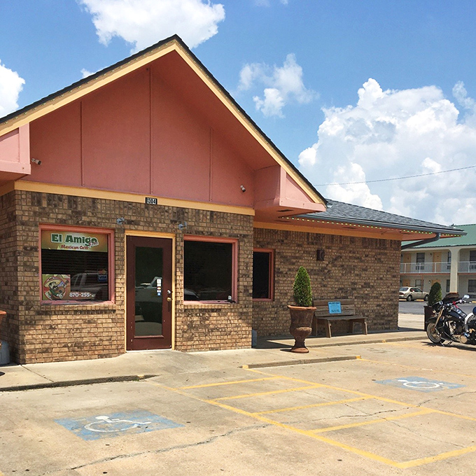 The daytime view reveals the restaurant's cheerful pink accents. This isn't just a building—it's a promise of good things to come.