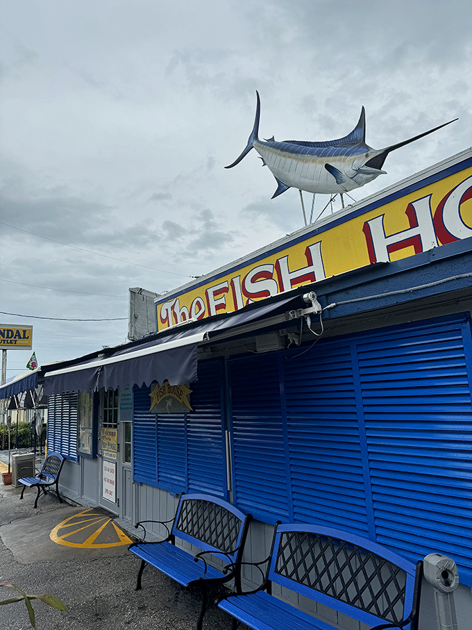 The Fish House's blue exterior stands ready for another day of seafood excellence. That marlin knows what's up.