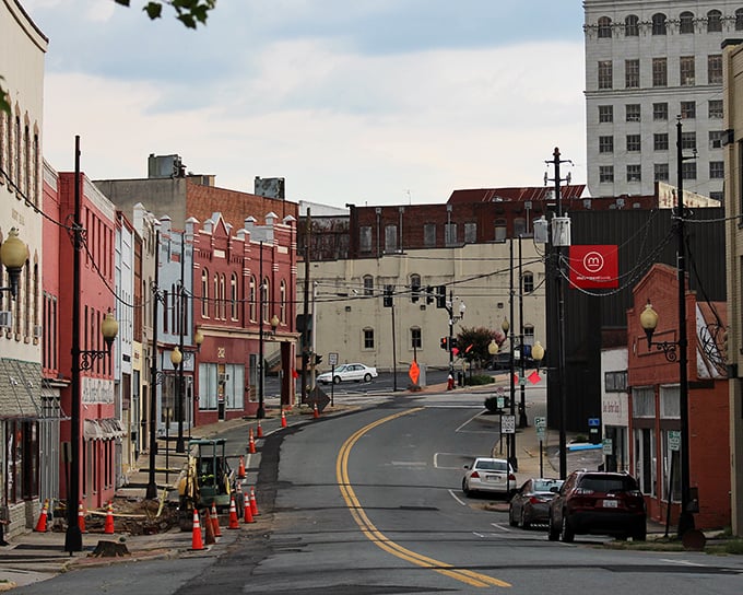 Red brick buildings line Danville's sloping Main Street, where ongoing revitalization efforts blend preservation with progress in this evolving Virginia gem.