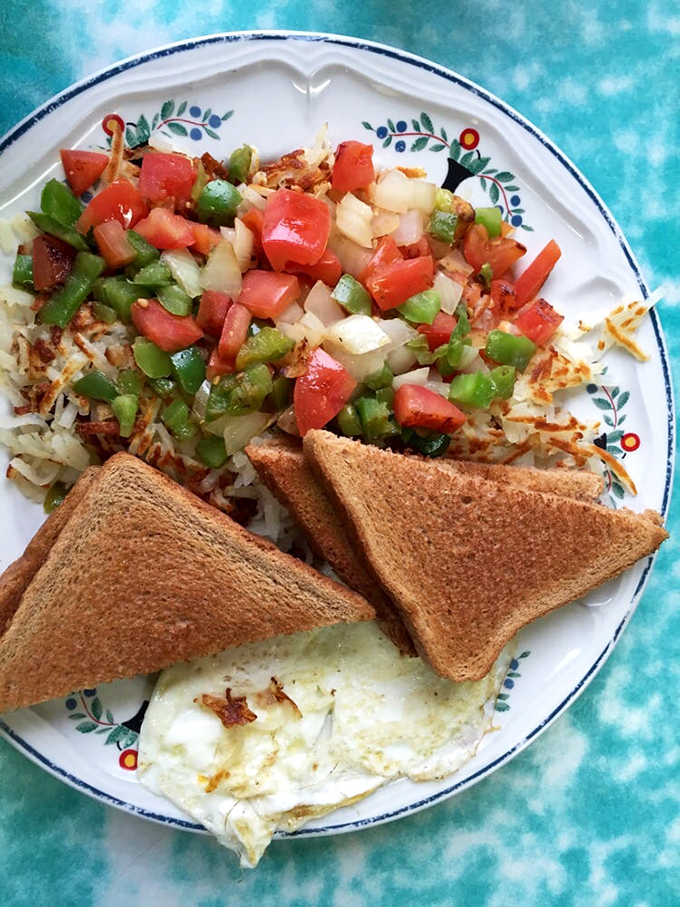 Hashbrowns topped with fresh veggies, toast standing at attention, and eggs cooked just right. Breakfast perfection doesn't need to be complicated.