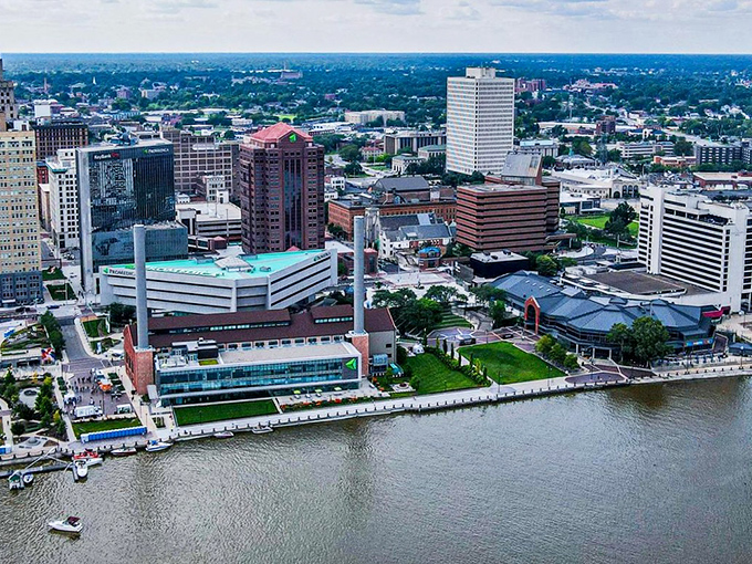 An aerial view reveals Toledo's harmonious relationship with the Maumee River that shaped its destiny. The city's compact downtown hugs the waterfront, creating a picturesque urban landscape.