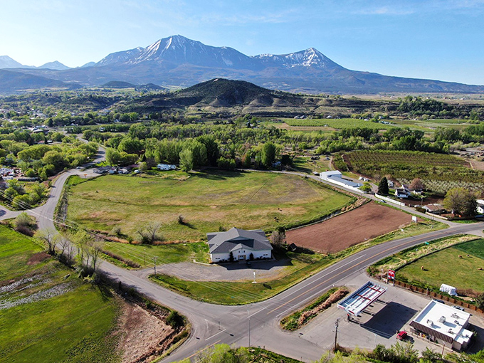 From above, Paonia reveals its perfect placement—nestled between mountains and mesas, orchards and vineyards, somehow both hidden and exactly where it should be.