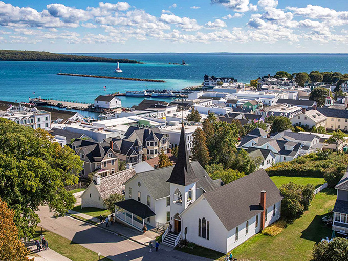 From above, Mackinac Island reveals itself as a perfect composition of white buildings, emerald trees, and the endless blue of Lake Huron.