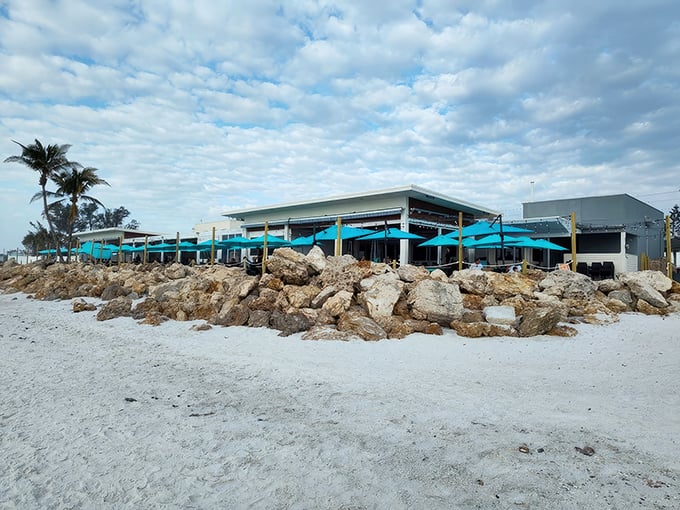 Beach House dreams come true! Colorful umbrellas dot the horizon where seafood meets shoreline in this Gulf Coast paradise.
