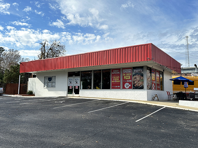 The bright red awning of Bussin Pizza beckons like a superhero cape for your hunger pangs. Simple outside, flavor explosion inside!