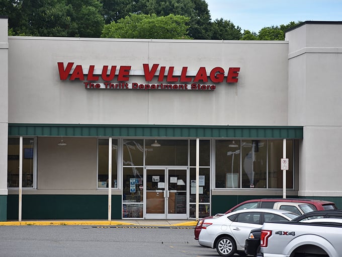 The iconic red sign of Value Village beckons like a lighthouse for bargain hunters. Treasure awaits inside!