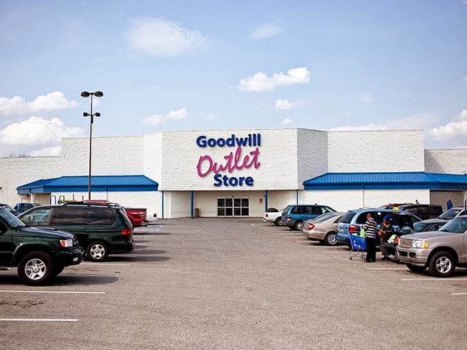 The blue sign beckons like a lighthouse to bargain hunters. Goodwill Outlet Store: where treasure hunting becomes an Olympic sport!