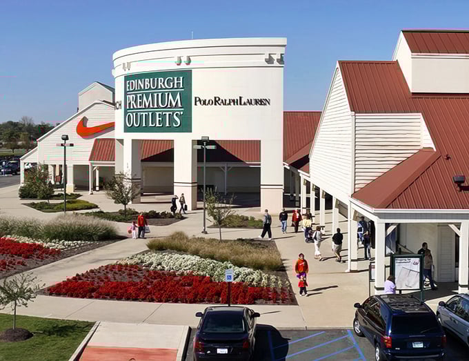 The grand entrance to Edinburgh Premium Outlets welcomes shoppers with colorful landscaping and the promise of designer deals ahead.
