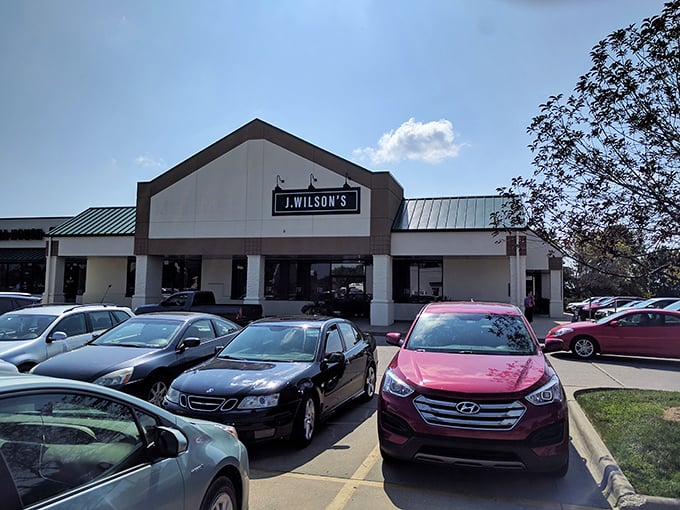 J. Wilson's exterior beckons with understated elegance. The packed parking lot tells you what locals already know—this place is worth the wait!