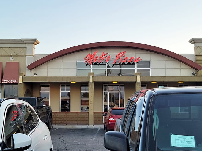 Metro Pizza's iconic red neon sign promises pizza paradise without the pretense. Simple surroundings, extraordinary slices.