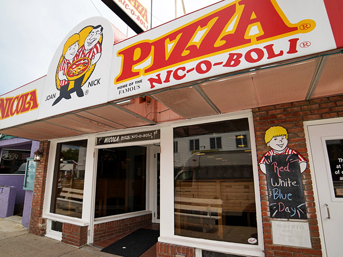 The iconic Nicola Pizza sign promises a taste of Delaware beach tradition that locals have sworn by for generations.