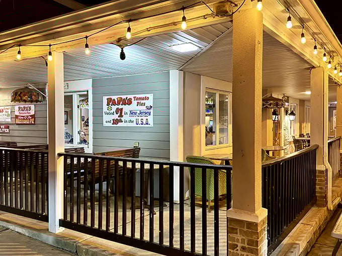 Papa's storefront glows with promise at dusk &ndash; like a beacon calling all pizza lovers home to the oldest tomato pie joint in America.