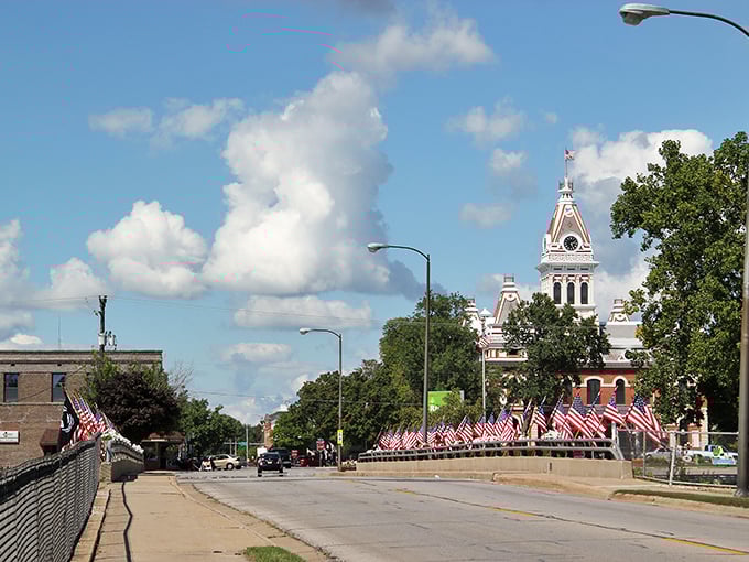 Pontiac's historic courthouse stands like a proud sentinel, with American flags creating a patriotic welcome that Norman Rockwell would have loved to paint.