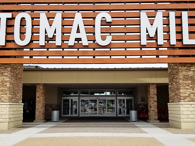 The grand entrance to Potomac Mills beckons like a siren song to bargain hunters. Stone pillars and that iconic sign promise retail therapy at its finest.