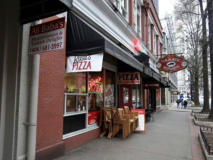 Rosa's Pizza storefront beckons with that classic red neon glow. Simple, unassuming, and promising New York-style pizza magic in downtown Atlanta.