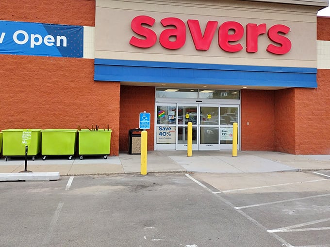 The bright red Savers sign beckons like a lighthouse to thrift enthusiasts navigating the sea of retail sameness.