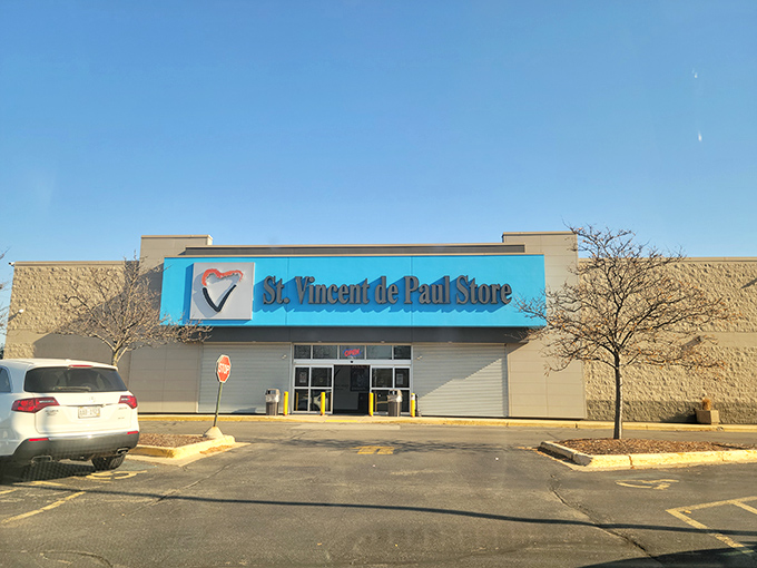 The blue storefront of St. Vincent de Paul beckons like a treasure island in a sea of asphalt.