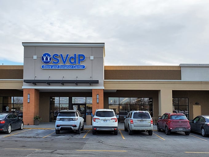 The blue SVdP sign beckons like a lighthouse to treasure hunters. This Omaha thrift mecca promises adventures in every aisle!