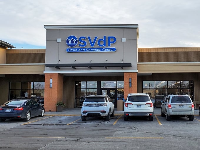 The blue SVdP sign beckons like a lighthouse to bargain hunters. This Omaha thrift mecca promises treasures behind those glass doors!