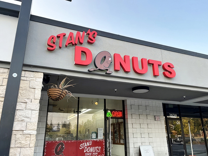 Stan's Donuts storefront beckons with its cheerful red sign &ndash; like a beacon of sugary hope in a strip mall sea.